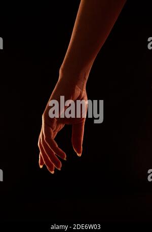 Beautiful Woman's Hand in Rim Light - Relaxed Stock Photo - Alamy