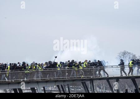 Protesters wearing yellow vests take part in a demonstration by the ...