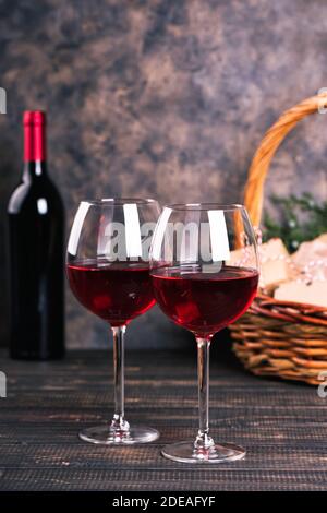 Basket with Christmas gift boxes, champagne, oranges and decor Stock ...