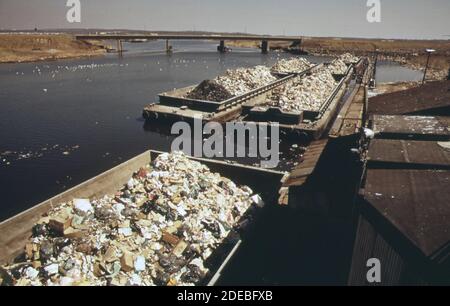 GARBAGE SCOWS FROM MANHATTAN WAIT TO BE UNLOADED AT THE STATEN ISLAND ...