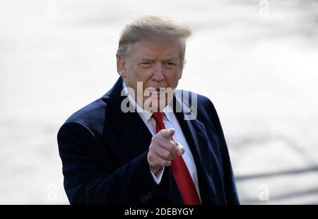 President Donald Trump talks with reporters as he arrives for the ...