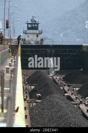 A COALBURG TUG AND EIGHT COAL BARGES GO DOWNSTREAM THROUGH THE LONDON ...