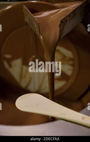 Mixing and blending Dark chocolate by an artisanal chocolatier Stock ...