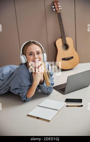 Caucasian woman songwriting with guitar in a music studio Stock Photo ...