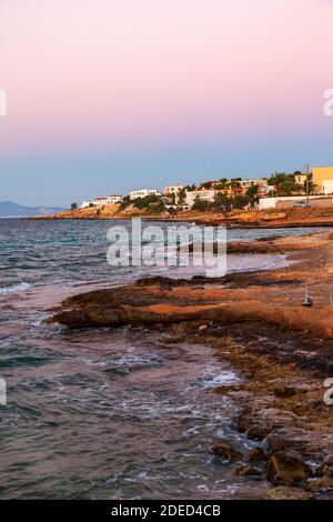 Sunset at a rocky beach near Souvala village, in Aegina island, Attica ...