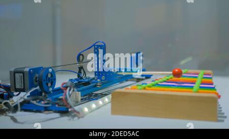 Robot playing on colorful xylophone at technology exhibition. Future ...