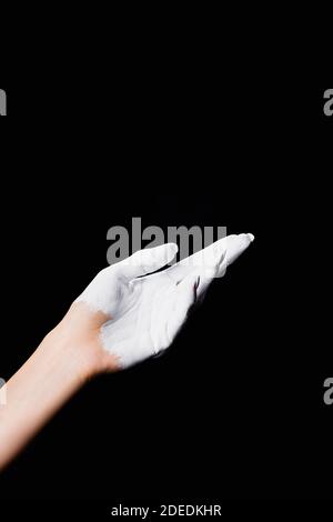 partial view of white painted hand isolated on black Stock Photo - Alamy