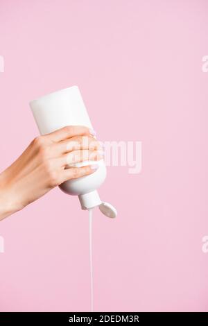 woman squeezing lotion on her hand, on green background close-up Stock ...