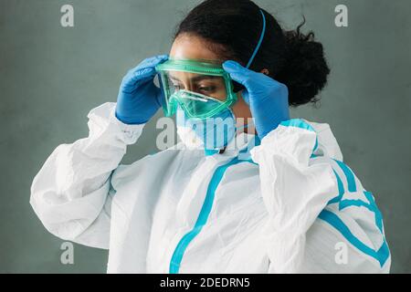 Young woman putting covid-19 face mask. Person wearing surgicak mask ...