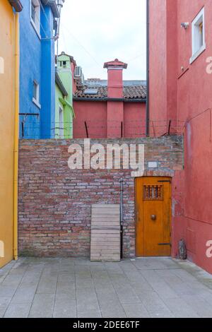 Brick Wall With Door Between Buildings in Burano Venice Stock Photo - Alamy