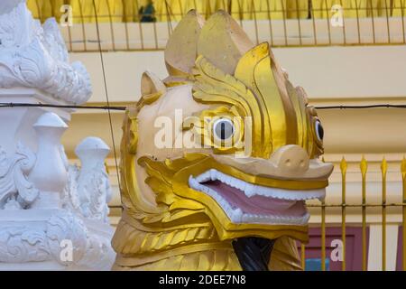 Golden chinthe (half lion, half dragon) statues sculptures with candles ...