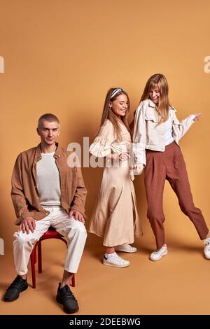 Cool cheerful teenage hipster in overalls and yellow hat standing ...
