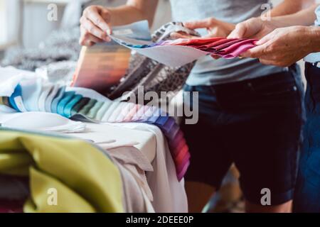 Hands on fabric pattern palette on studio table Stock Photo - Alamy