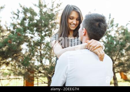 young, happy, loving couple, frolic and have fun in the Park, and enjoy ...