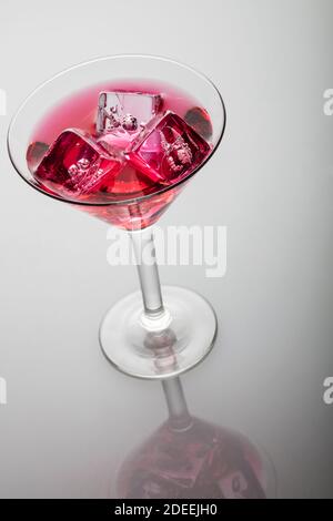Red martini with ice cubes shot in studio Stock Photo - Alamy
