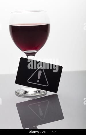 Warning sign in front of wine glass Stock Photo - Alamy