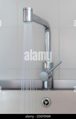 Open tap water with chrome faucet Stock Photo - Alamy