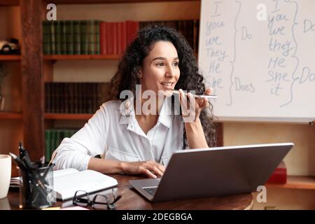 Young lady using voice assistant on cellphone and pc Stock Photo - Alamy