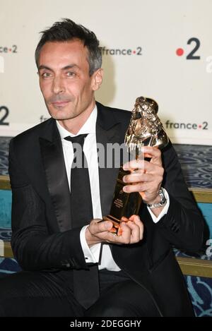 Benoit Soles posing with his award for 'La machine de Turing' during ...