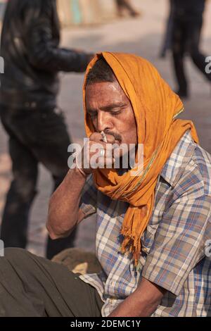 Nepalese man smoking a cigarette Stock Photo - Alamy
