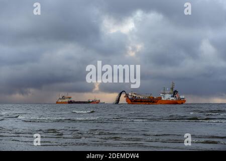Vessel engaged in dredging. Dredger working at sea. Ship excavating ...