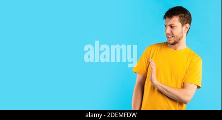 Shocked guy with disgusted face showing stop sign Stock Photo - Alamy