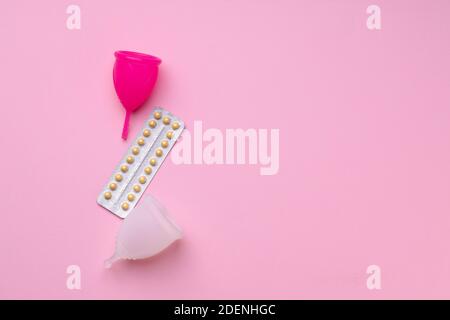 Menstrual cup and oral contraceptive pills top view Stock Photo - Alamy