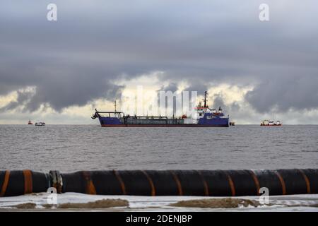 Vessel engaged in dredging. Dredger working at sea. Ship excavating ...
