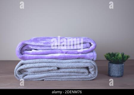 Winter blanket on a wooden table. Clothes with different patterns of ...