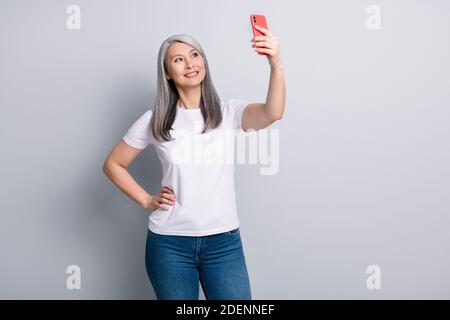Photo of shiny sweet girl dressed striped t-shirt reading modern gadget ...