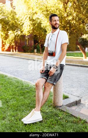 Close-up of a photographer shooting a city view in the cold autumn ...