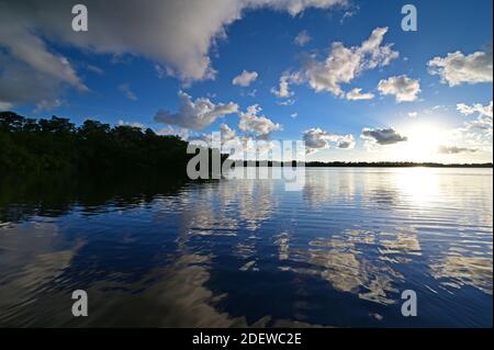 Afternoon cloudscape reflected on calm water of Paurotis Pond in ...