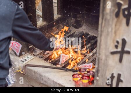 People burn joss paper gold and silver paper for worship with paper ...