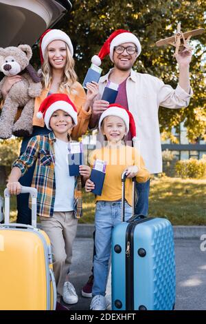 Father and son in santa hats making smartphone christmas video call ...