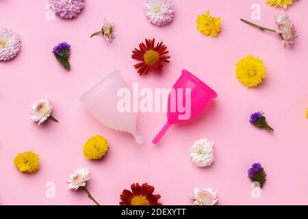 Menstrual cup on floral pattern background top view Stock Photo - Alamy