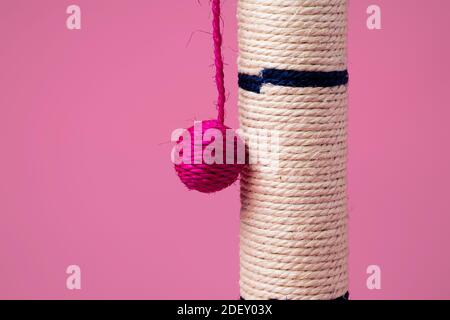 Scratching post for cats on pink background Stock Photo - Alamy