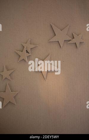 Cardboard stars on a brown background. Eco-style Stock Photo - Alamy