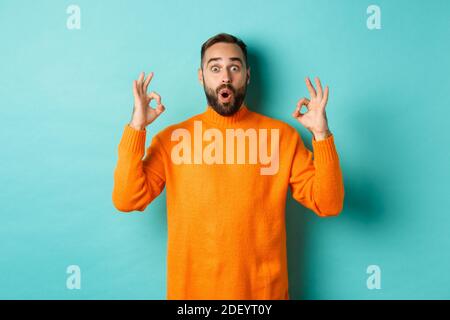 Impressed man praising something super cool, showing okay sign and ...