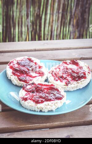 Delicious corn cake on a black plate, presented on a vibrant red ...