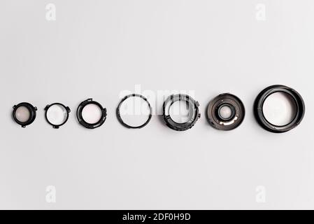 camera lens disassembled. elements and pieces of lens glass lay on ...