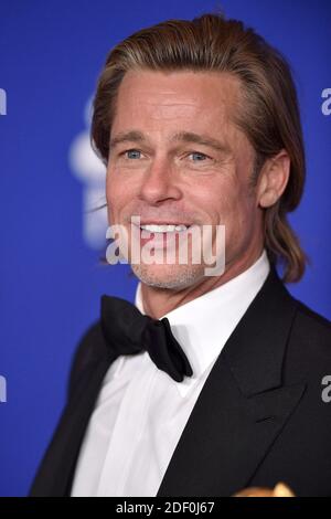 Brad Pitt poses in the press room with the award for best performance ...