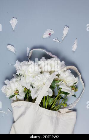 Textile eco bag and cotton flowers on paper background Stock Photo - Alamy