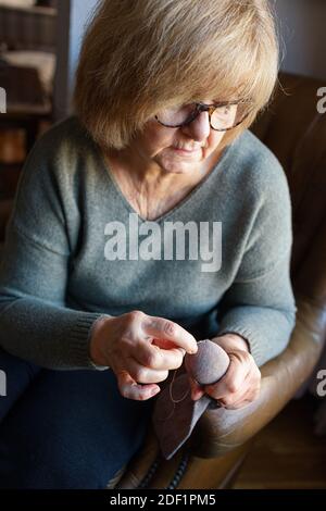 Old woman mending a sock at home Stock Photo - Alamy