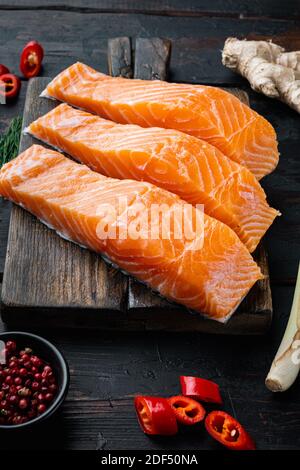 Fishcakes ingredient with salmon herbs and spices, on black wooden ...