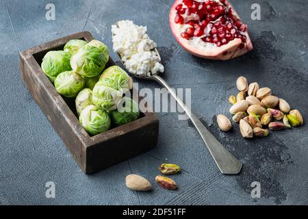 Gnarly garlic brussels ingredient, on black textured background with ...
