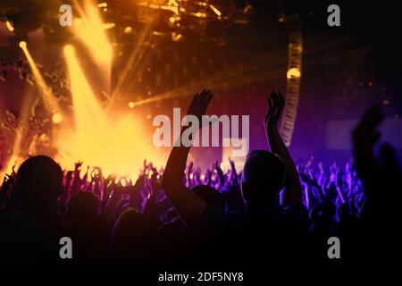 A fan at a concert of his favorite musical group, raised hands Stock ...