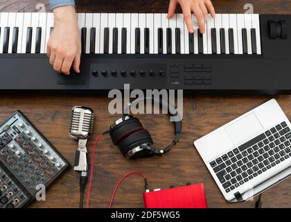 Sound engineer working in his home studio with DAW software on computer ...
