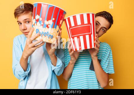 Image of two frightened teenagers, guys watching a horror movie and ...