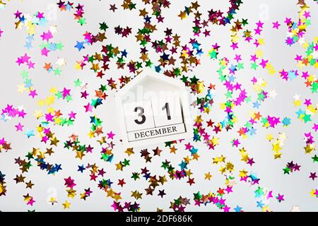 31 December calendar and colorful confetti on white. Happy new year ...