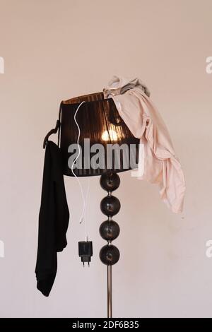 Clothes on the lamp, wardrobe mess Stock Photo - Alamy